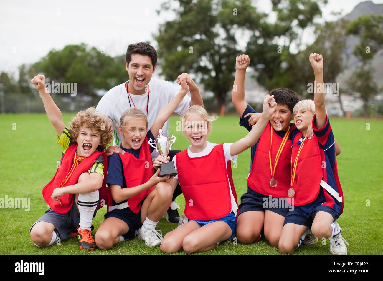 Children cheering with coach Stock Photo - Alamy