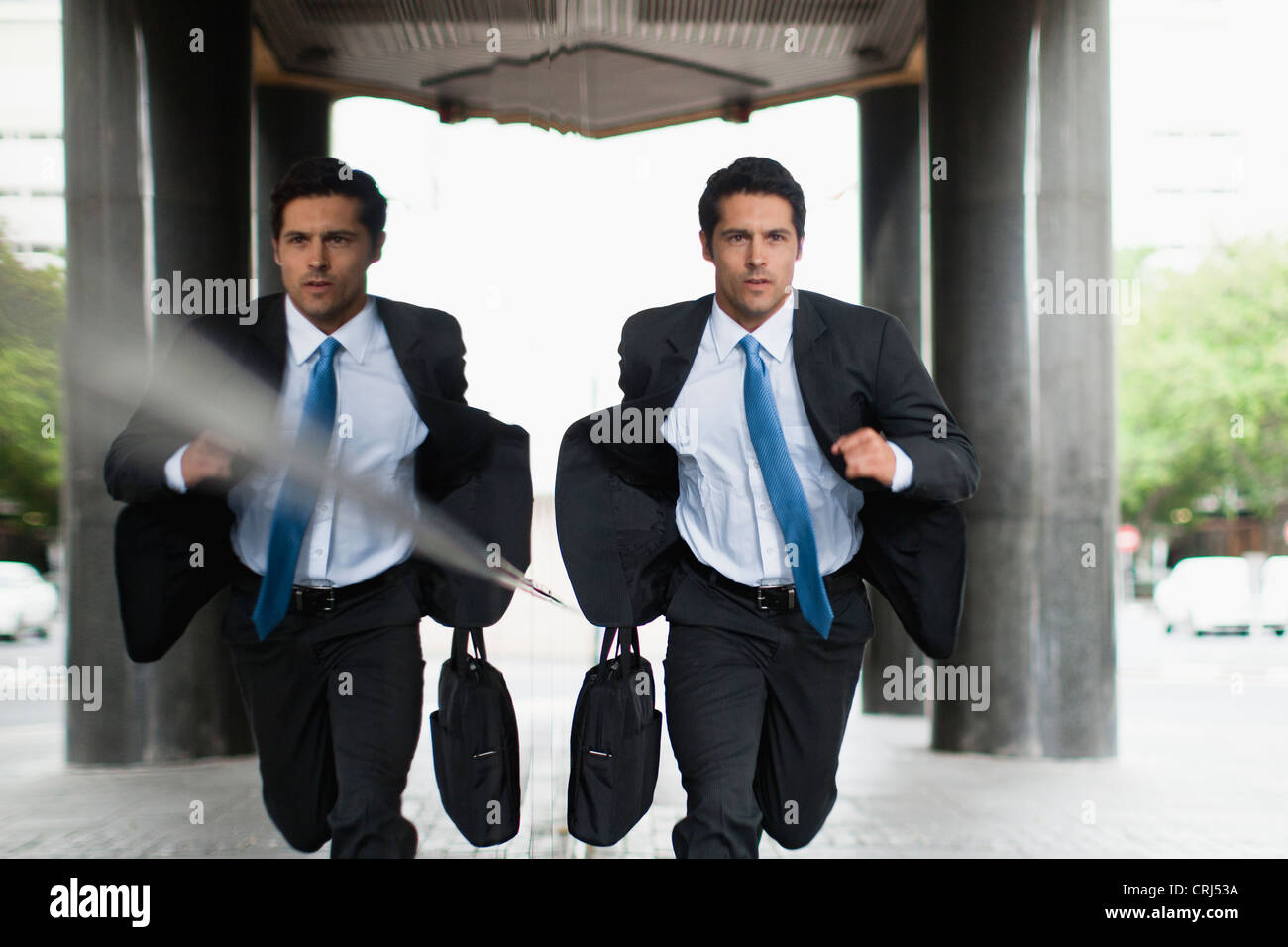 Businessman running on city street Stock Photo - Alamy