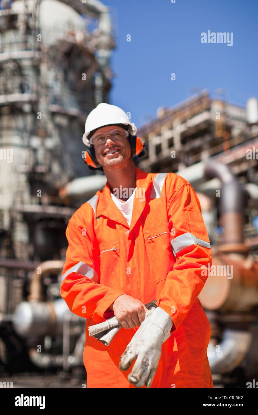 Worker with gloves at oil refinery Stock Photo - Alamy