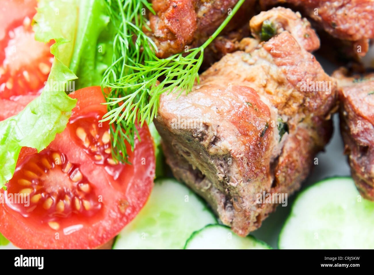 grilled kebab with tomatoes and green vegetables Stock Photo - Alamy