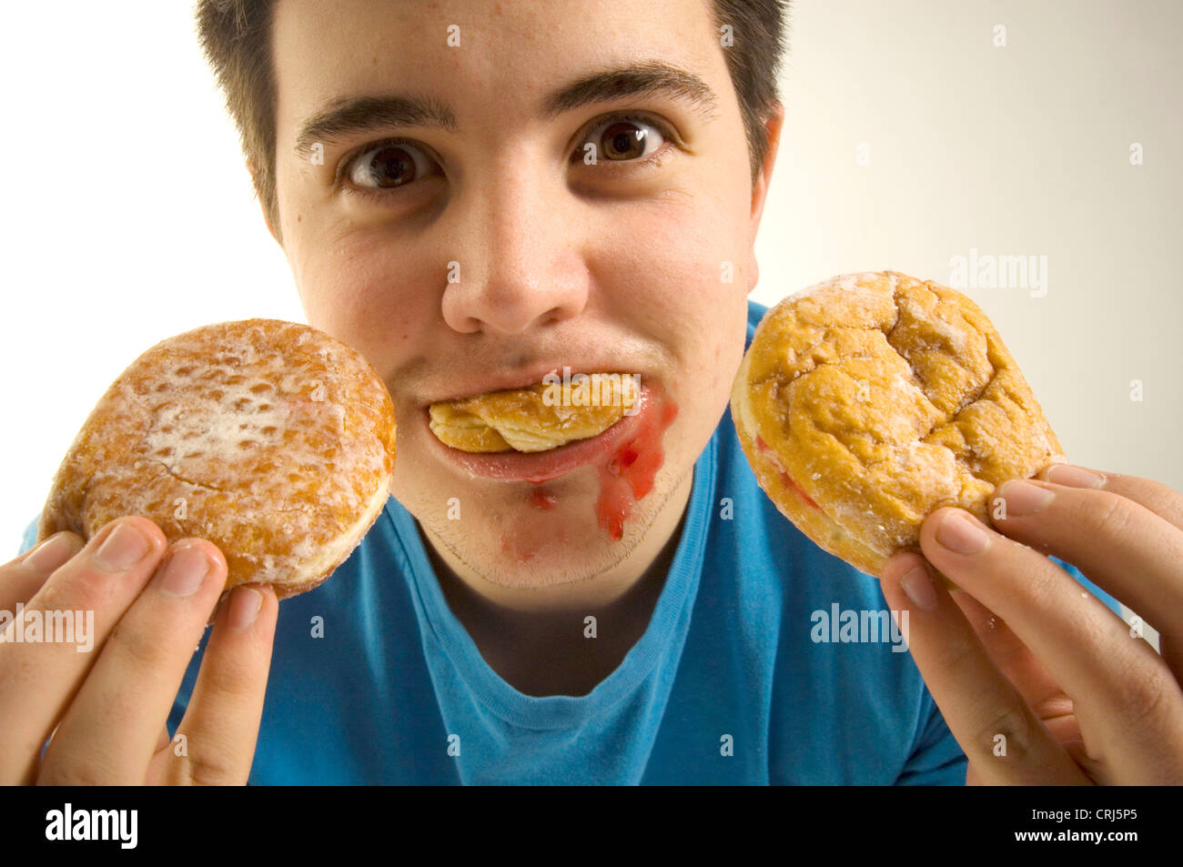 A young male jam donut junkie. Jam donuts have been criticized by junk ...