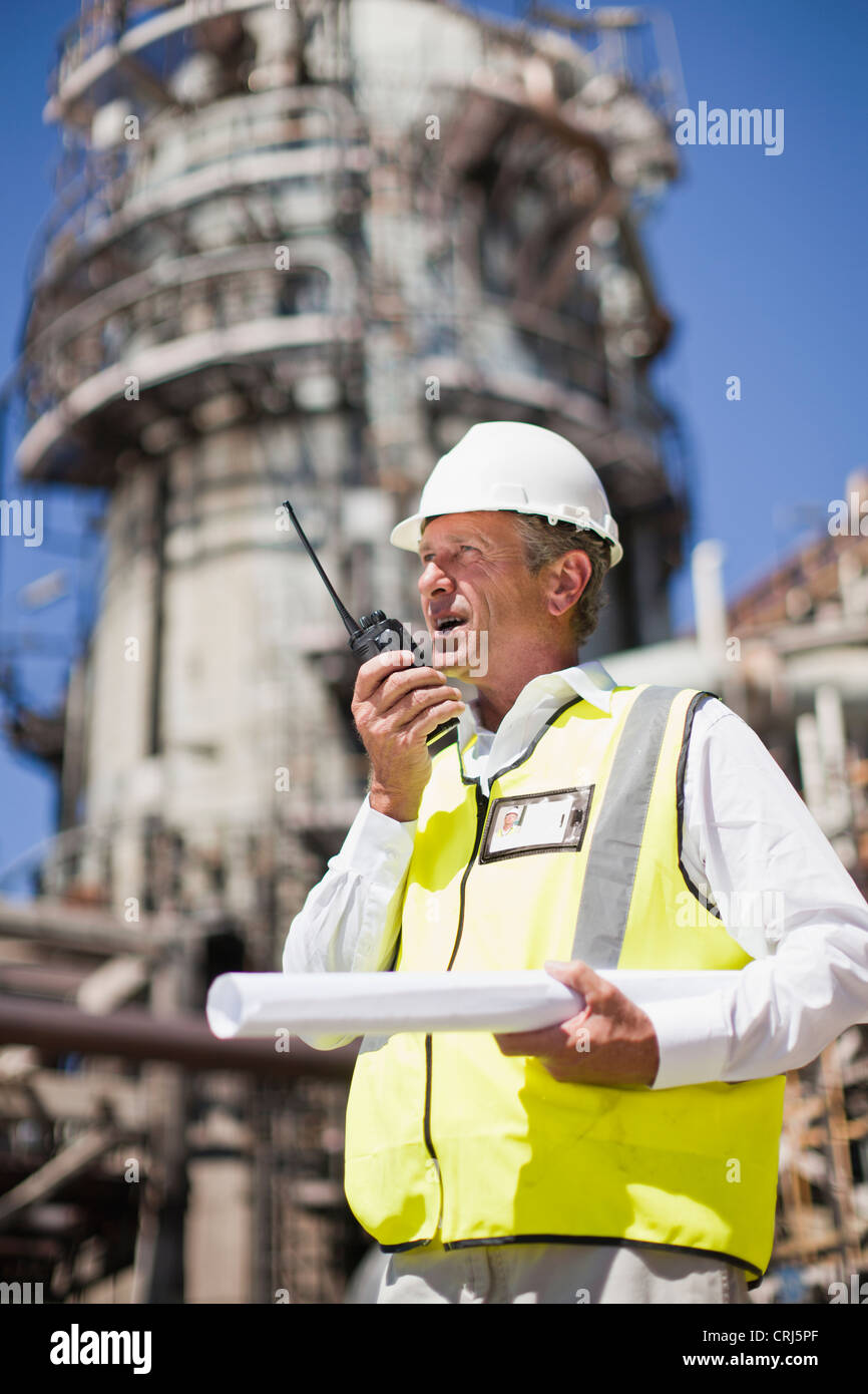 Worker with walkie talkie on site Stock Photo - Alamy