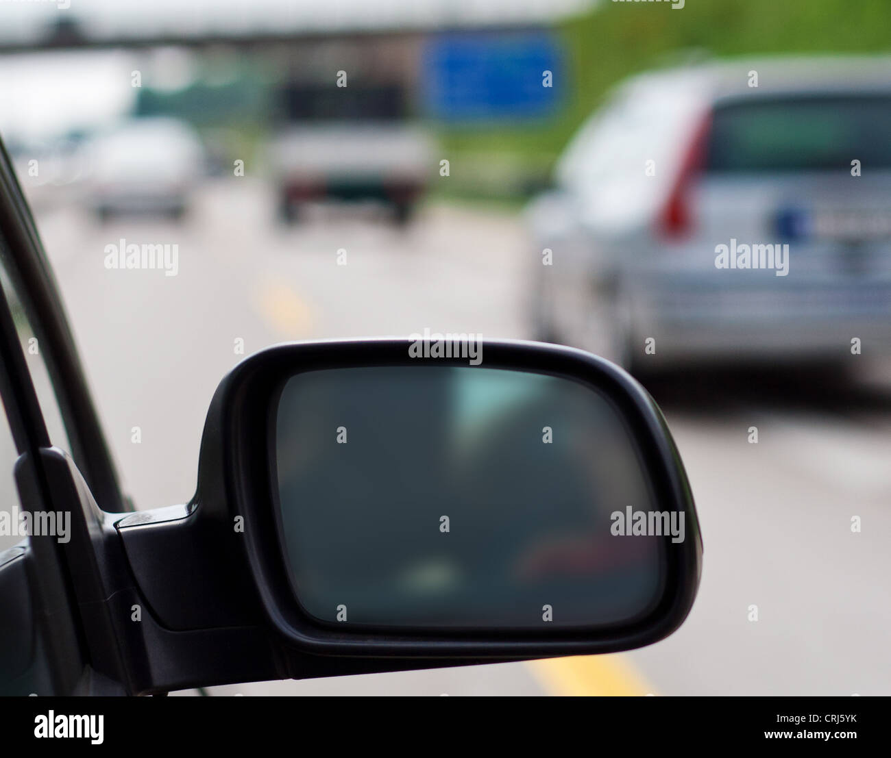 Rearview mirror of a car driving on german autobahn Stock Photo - Alamy