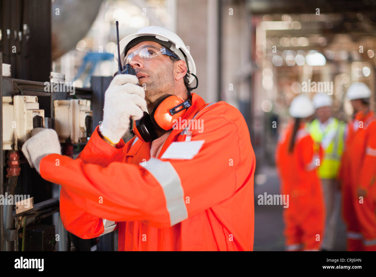 Worker with walkie talkie on site Stock Photo - Alamy