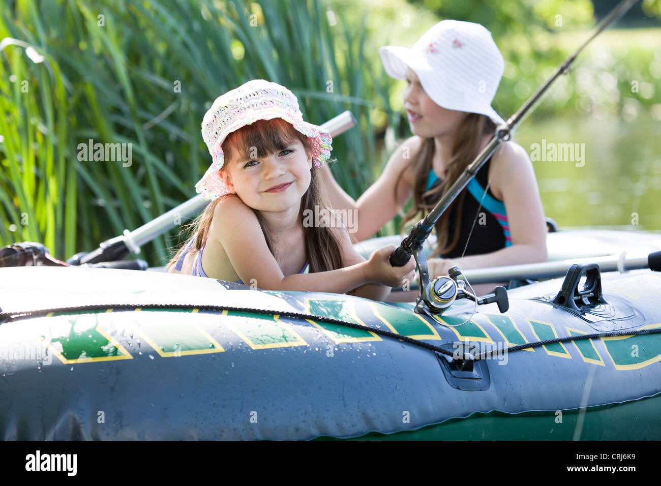 little girls fishing on lake at summer Stock Photo - Alamy