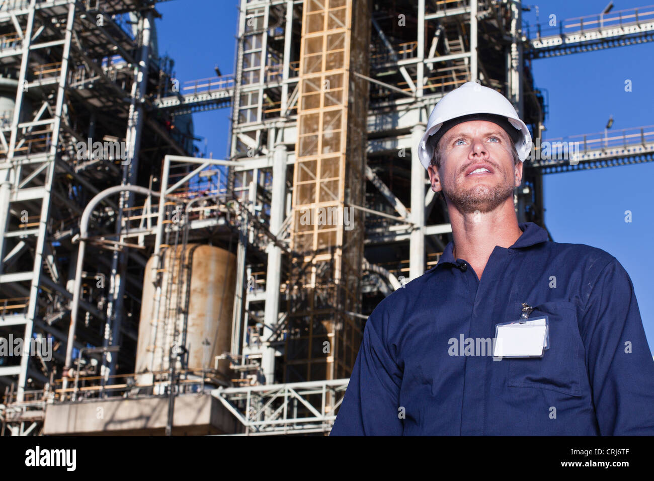 Worker standing at oil refinery Stock Photo - Alamy
