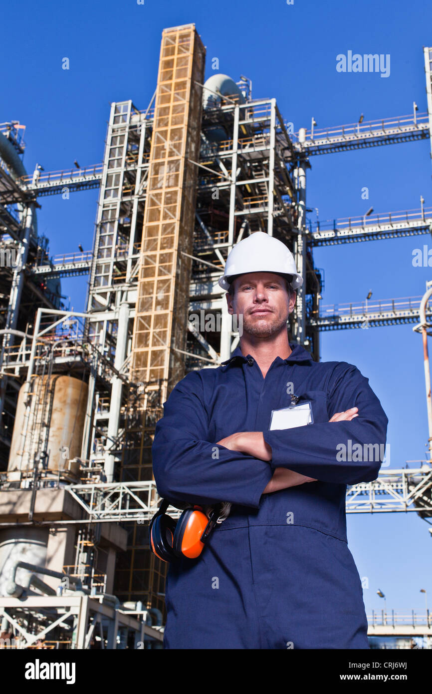 Worker standing at oil refinery Stock Photo - Alamy