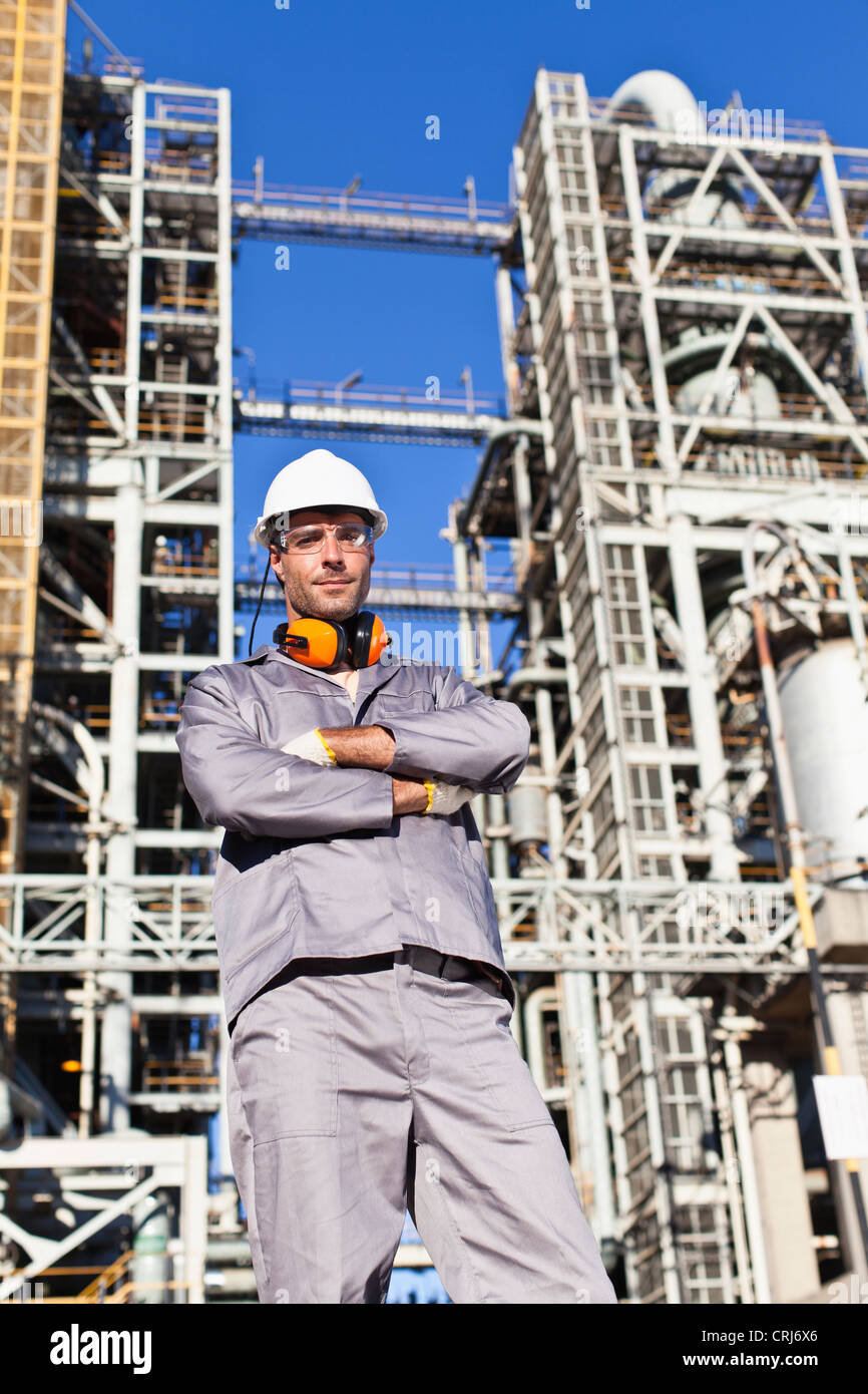 Worker standing at oil refinery Stock Photo - Alamy