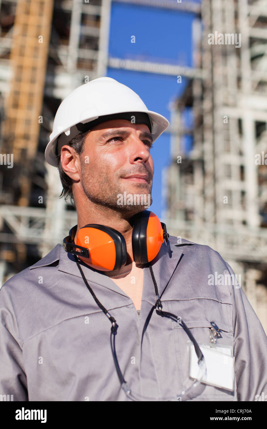Worker standing at oil refinery Stock Photo - Alamy