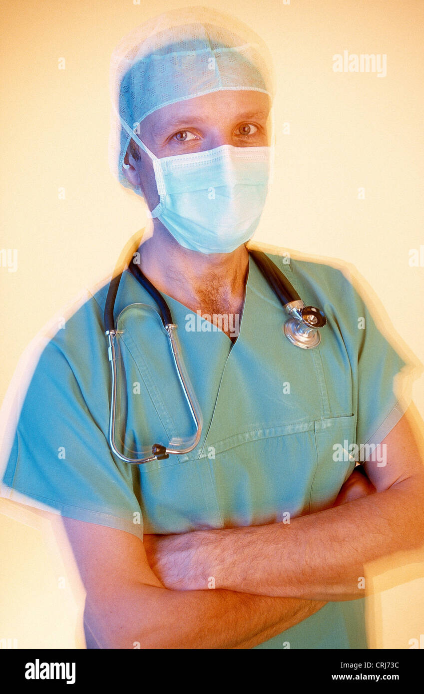 Doctor with scrubs, cap, surgical mask and a stethoscope Stock Photo ...