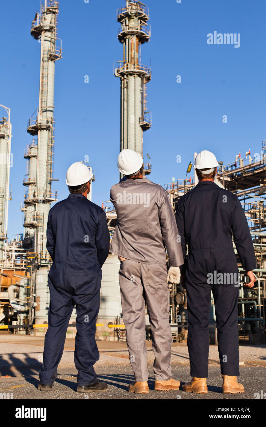 Man looking up at oil refinery hi-res stock photography and images - Alamy