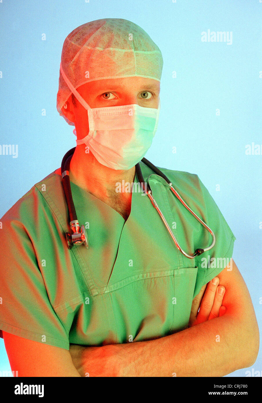 Doctor with scrubs, cap, surgical mask and a stethoscope Stock Photo ...