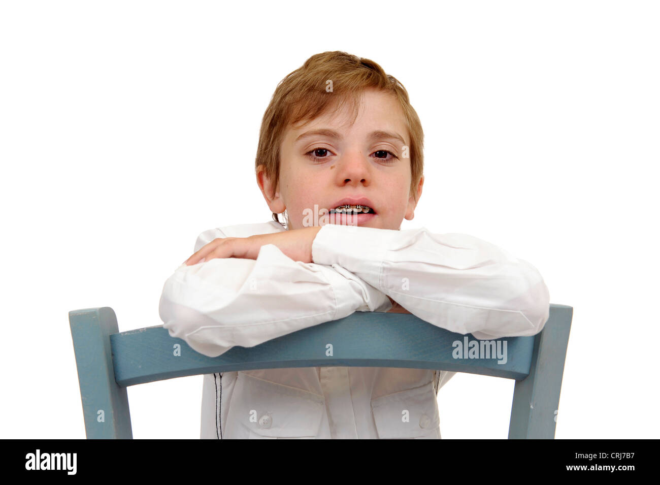 boy sitting on a chair Stock Photo - Alamy