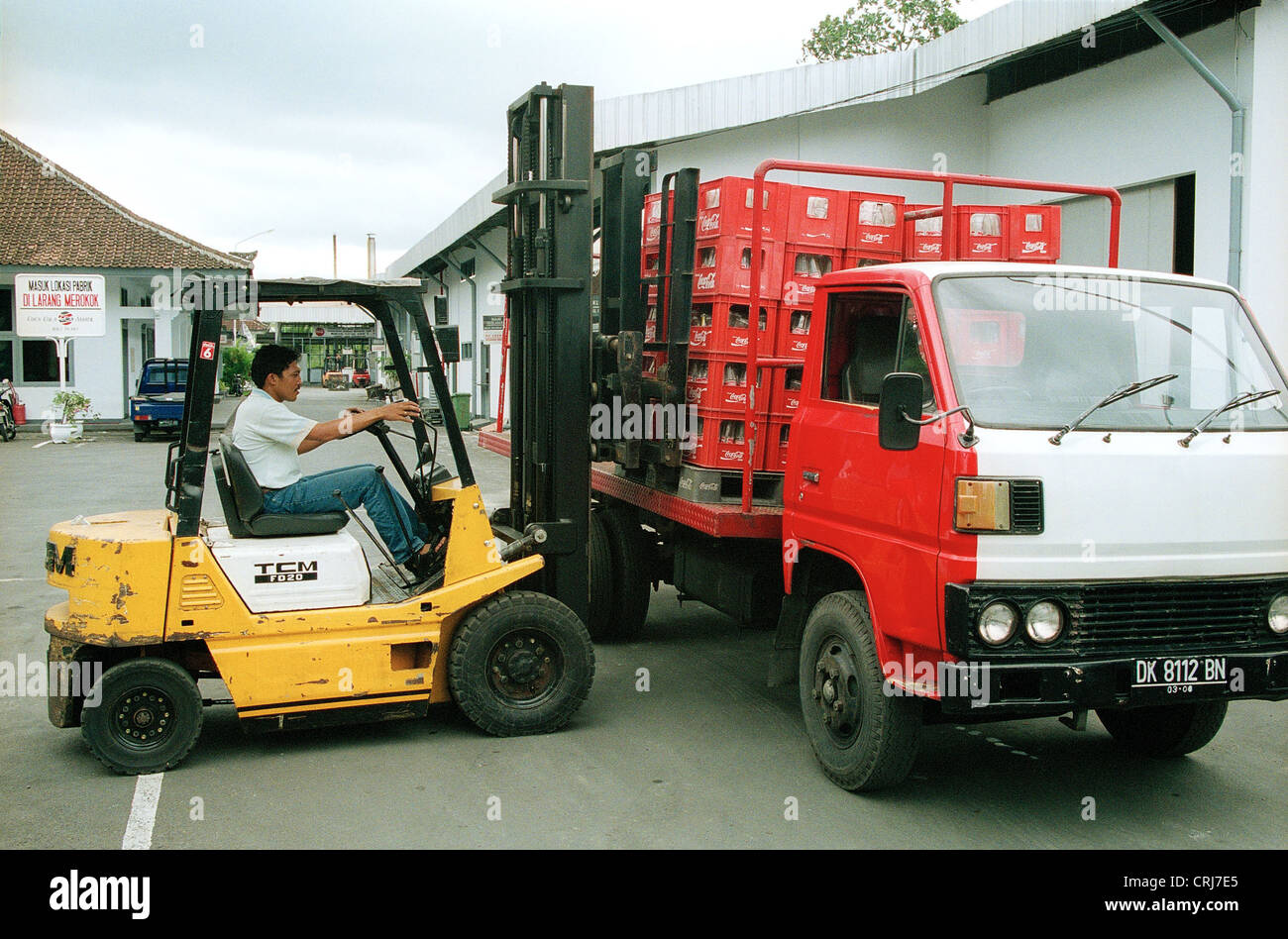 Loading a van with boxes of Coca-Cola brand in Bali Stock Photo - Alamy