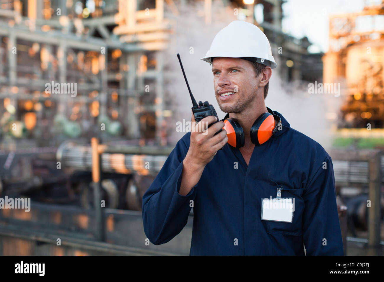 Worker using walkie talkie on site Stock Photo - Alamy