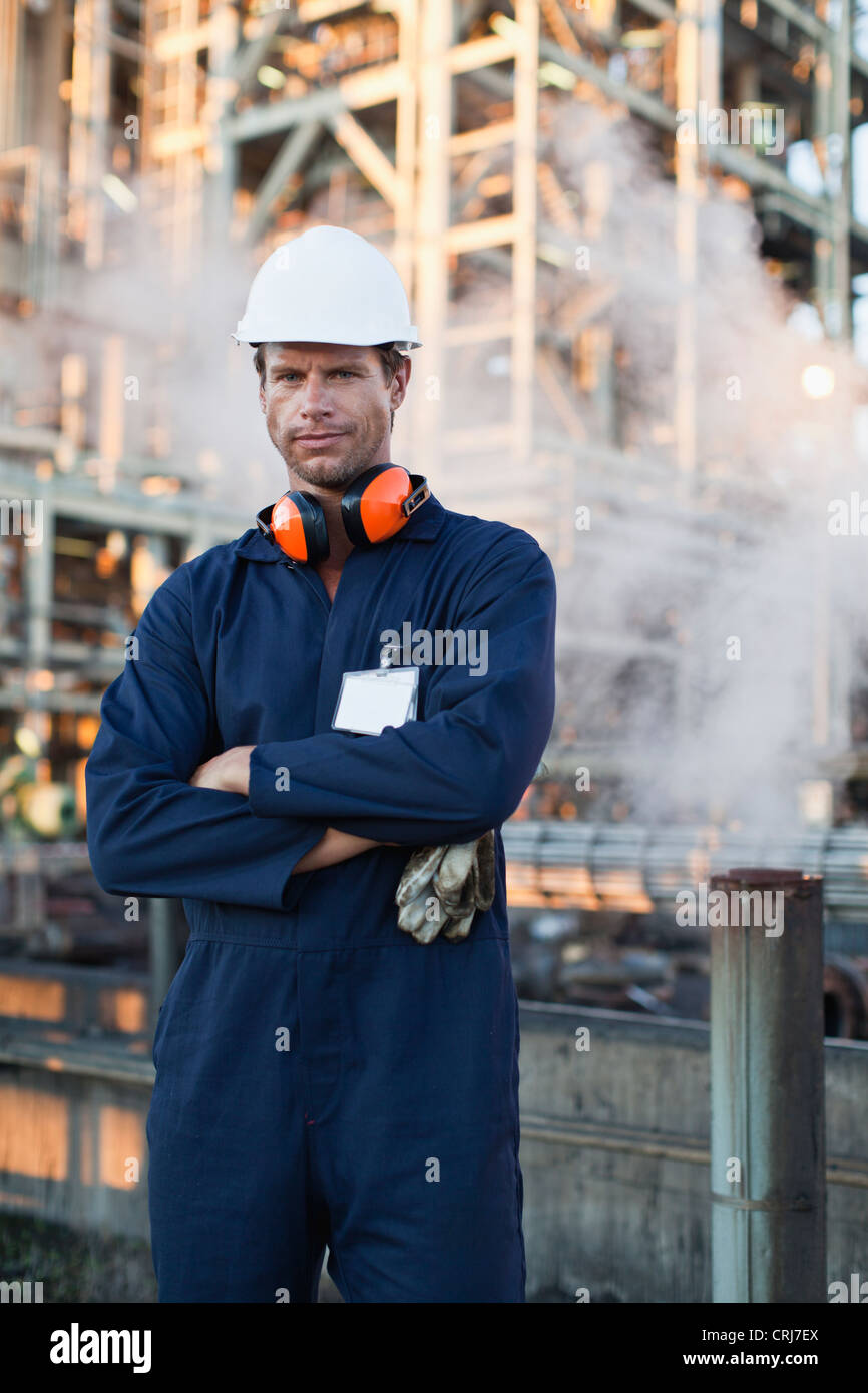 Worker standing at oil refinery Stock Photo - Alamy