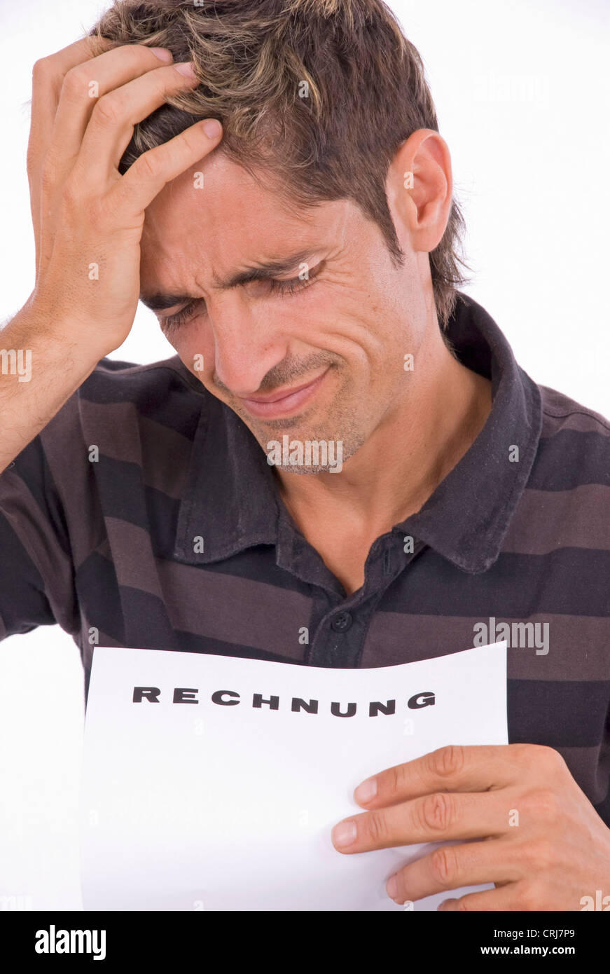 desperate man with a bill in hand holding his head Stock Photo - Alamy