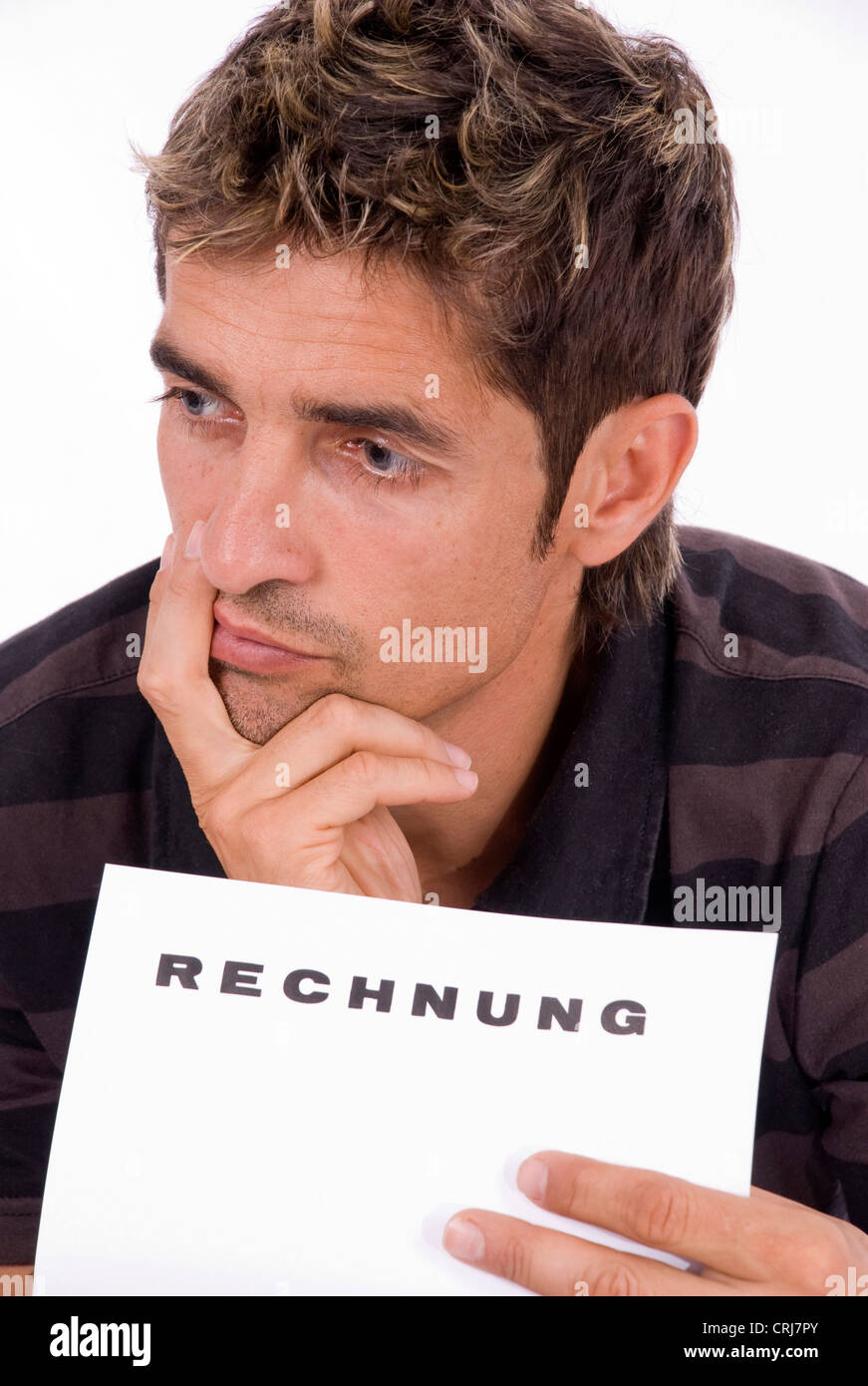 perplexed man with a bill in one hand and the chin in the other Stock ...