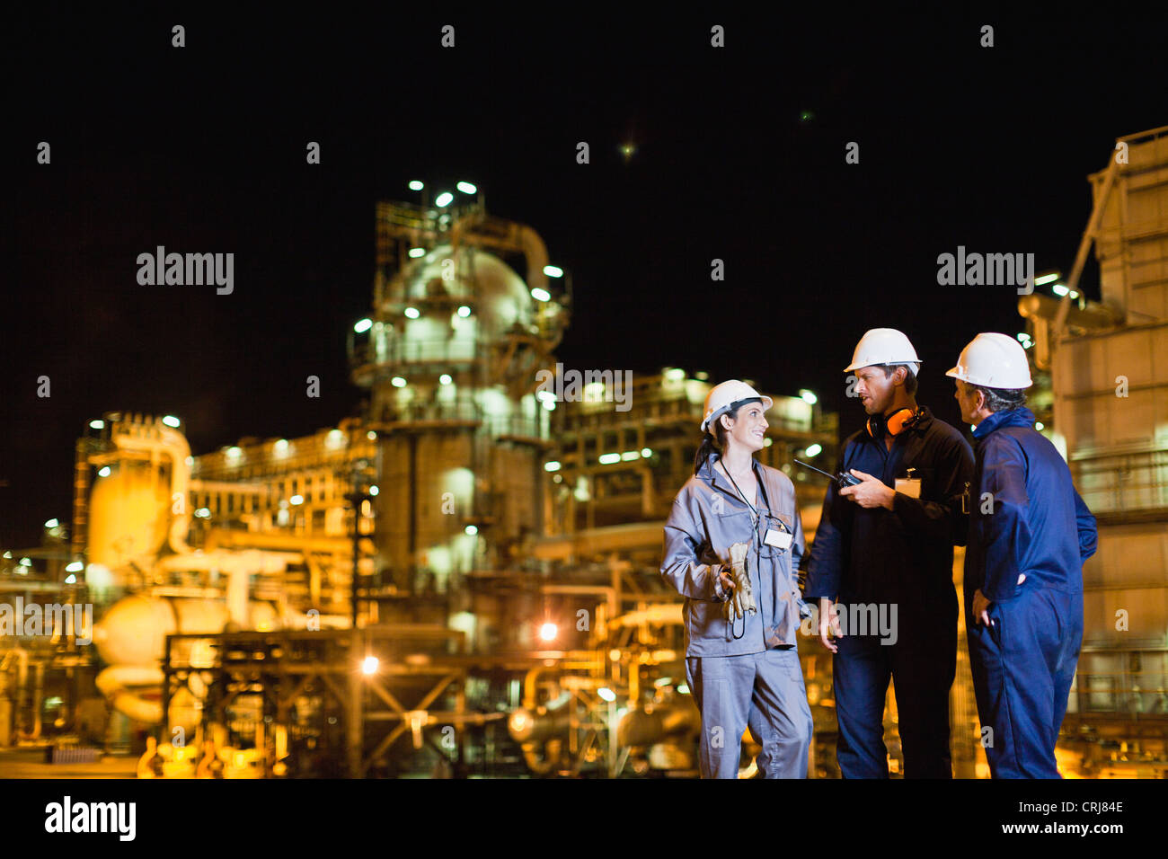 Workers talking at oil refinery Stock Photo - Alamy