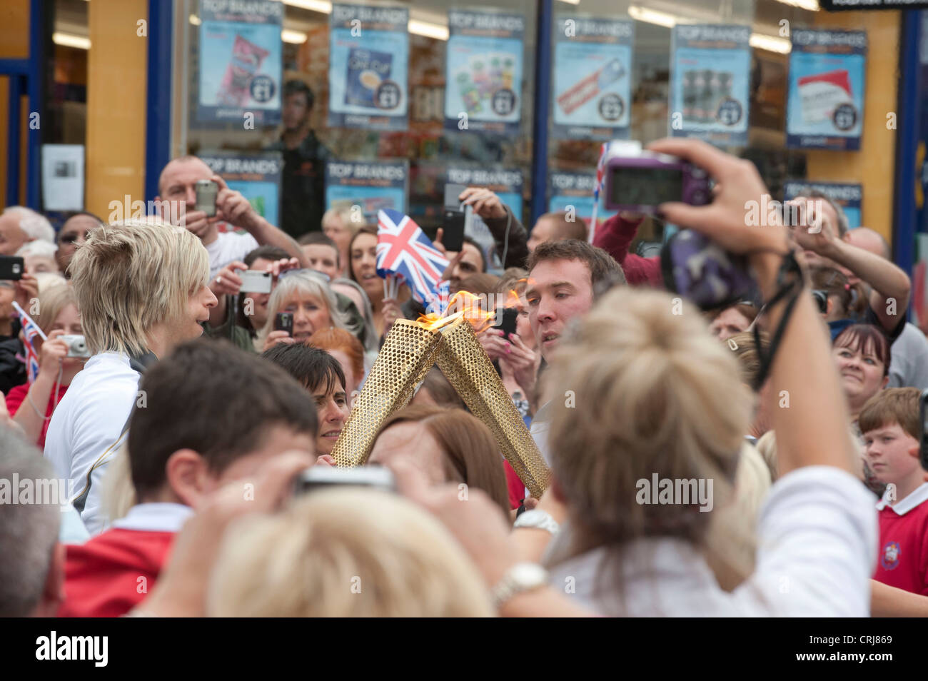 Olympic torch relay changeover in Wakefield from Jono Lancaster to ...