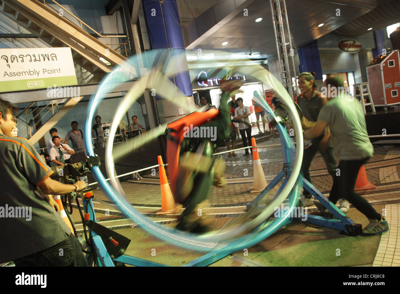 People riding on Space Roller in amusement park at MBK shopping mall in ...