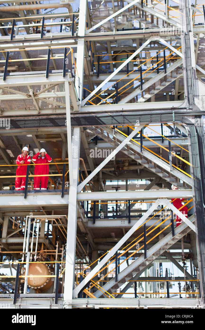 Workers talking at oil refinery Stock Photo - Alamy