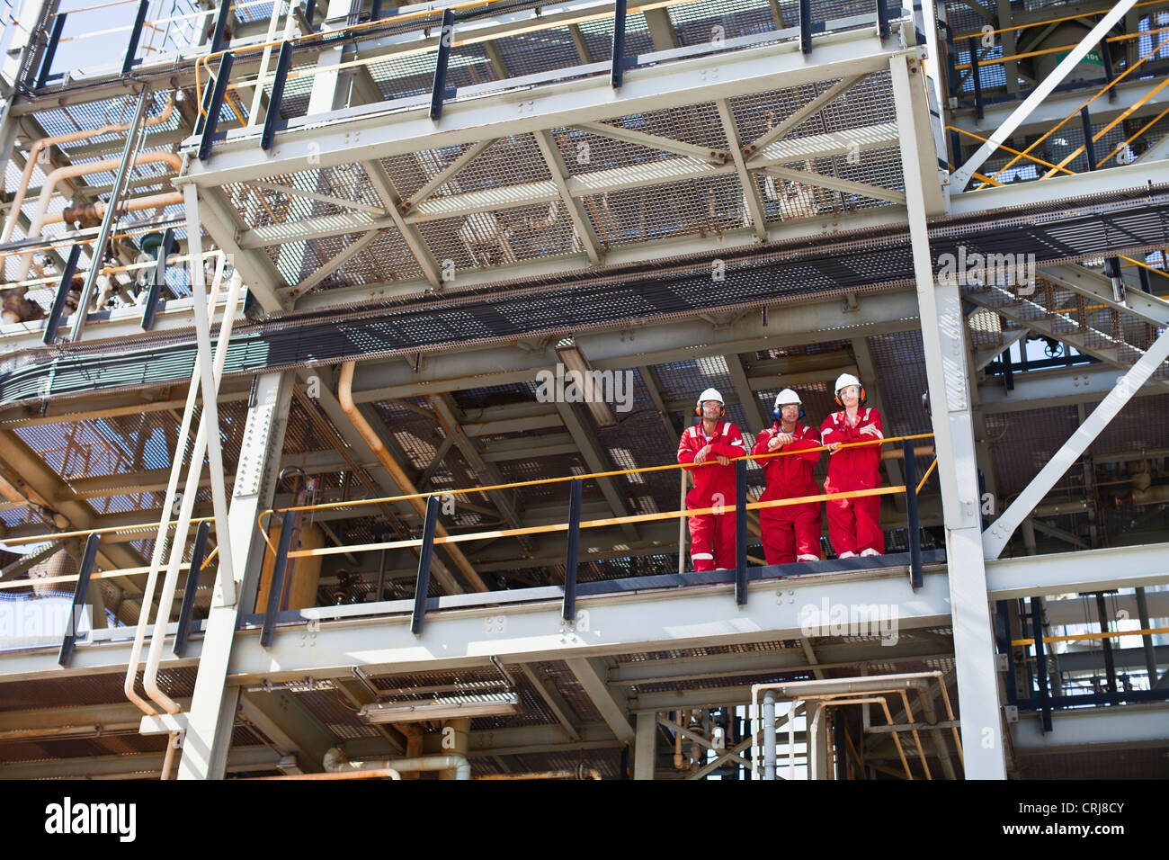 Workers standing on ledge together Stock Photo - Alamy