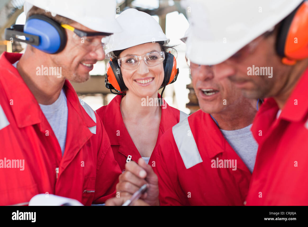 Workers talking at oil refinery Stock Photo - Alamy
