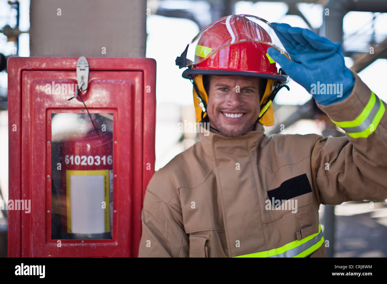 Firefighter smiling on site Stock Photo - Alamy