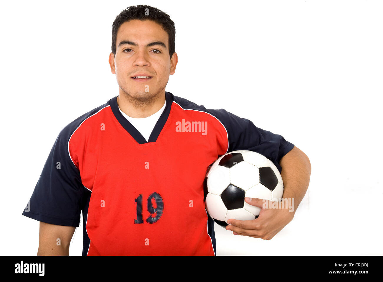 soccer player holding a ball under his arm with a smile Stock Photo - Alamy