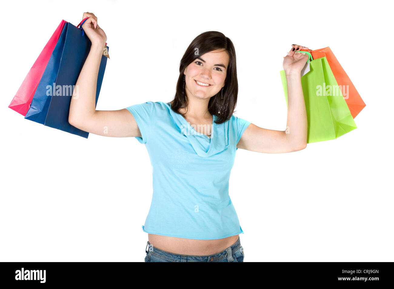 young girl holding up four shopping bags with a smile Stock Photo - Alamy