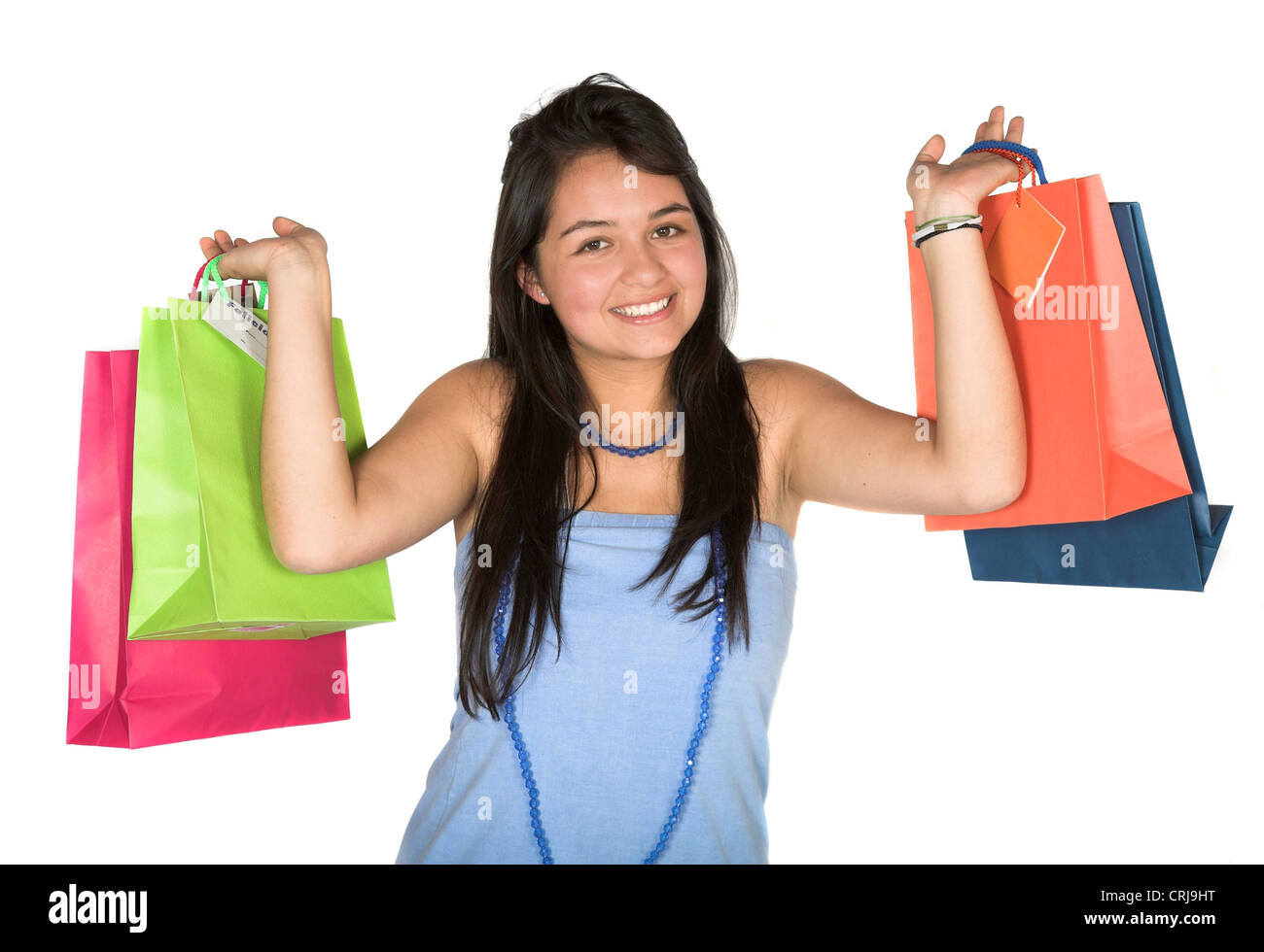 young girl holding up four shopping bags with a smile Stock Photo - Alamy