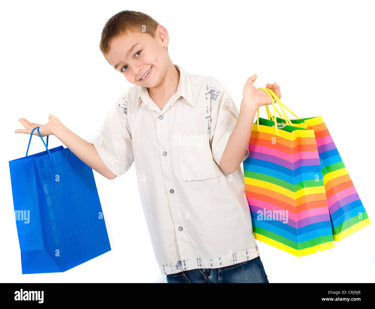 young boy holding up shopping bags with a smile Stock Photo - Alamy