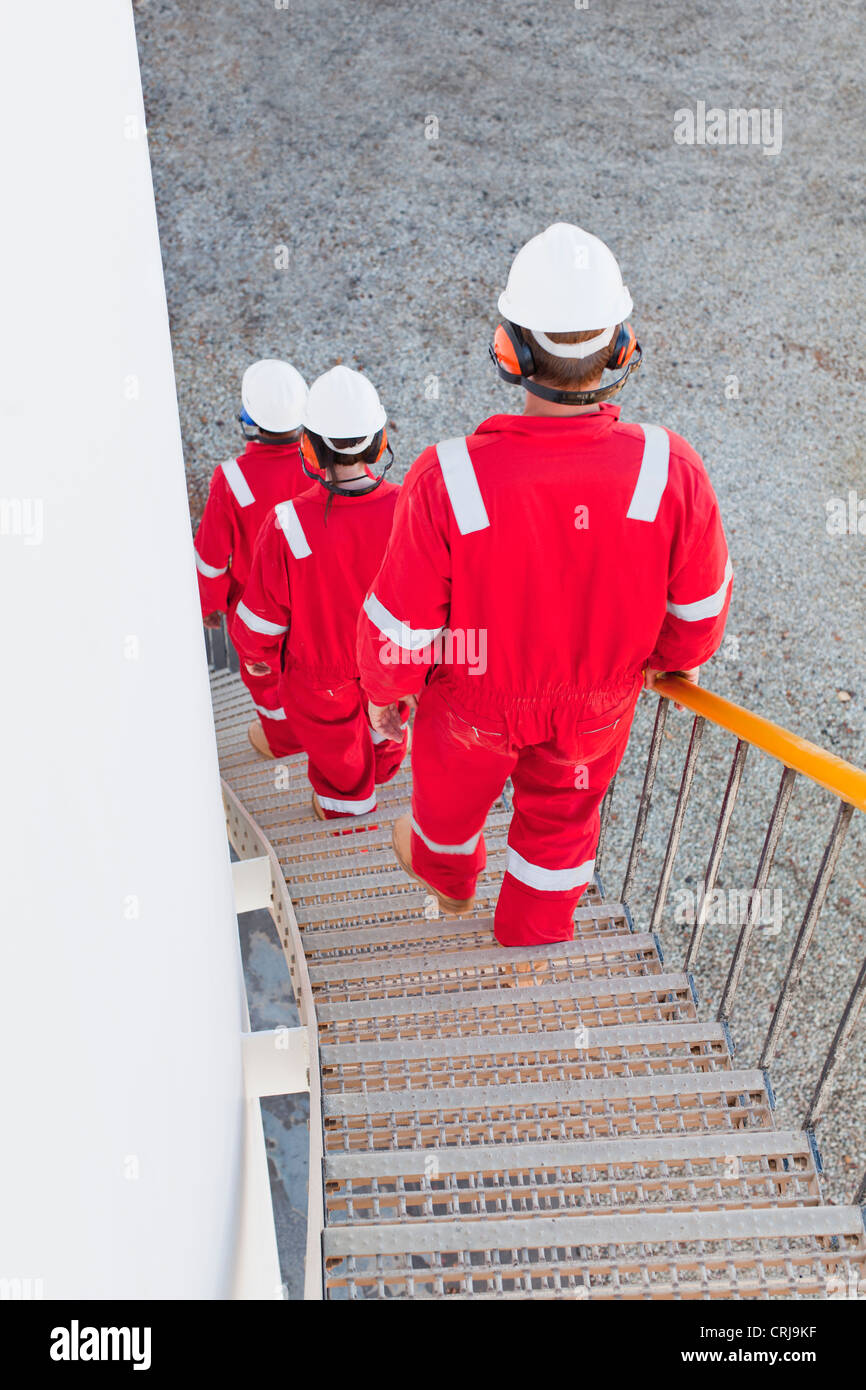 Workers on steps at chemical plant Stock Photo - Alamy