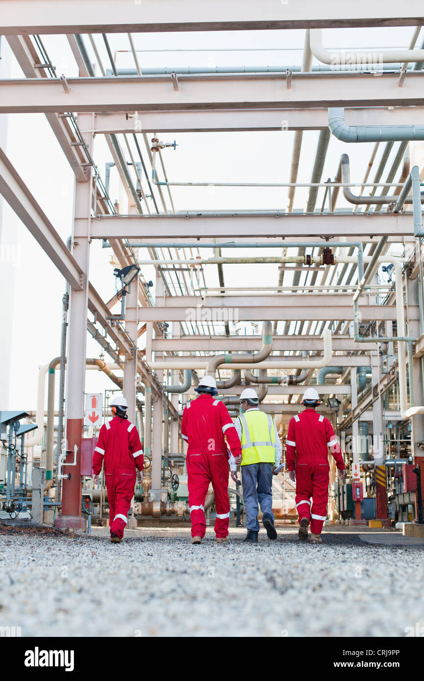 Workers walking at chemical plant Stock Photo - Alamy