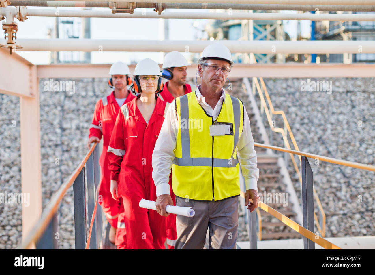 Workers walking at chemical plant Stock Photo - Alamy