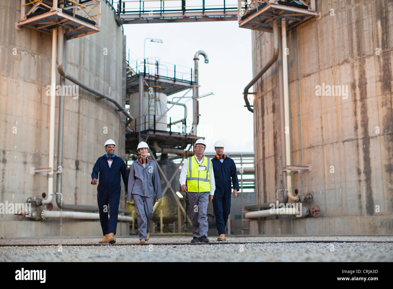 Workers walking at chemical plant Stock Photo - Alamy