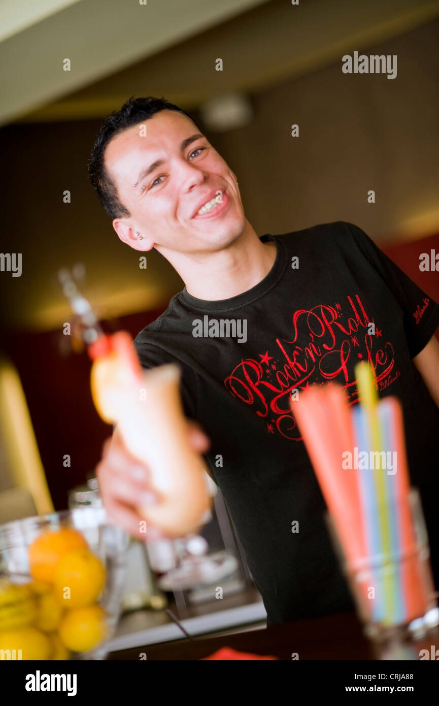 barkeeper serving a cocktail with a smile Stock Photo - Alamy