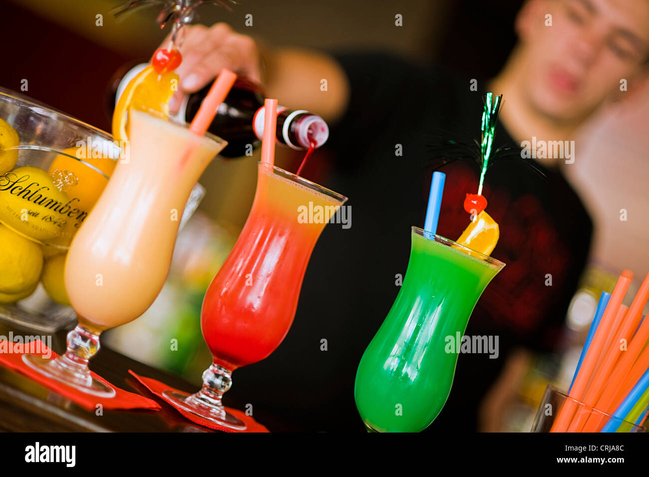 barkeeper mixing three different cocktails Stock Photo - Alamy
