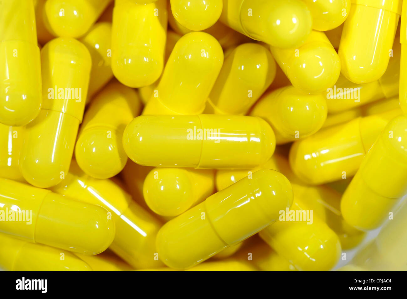 close-up of lots of yellow capsules Stock Photo - Alamy
