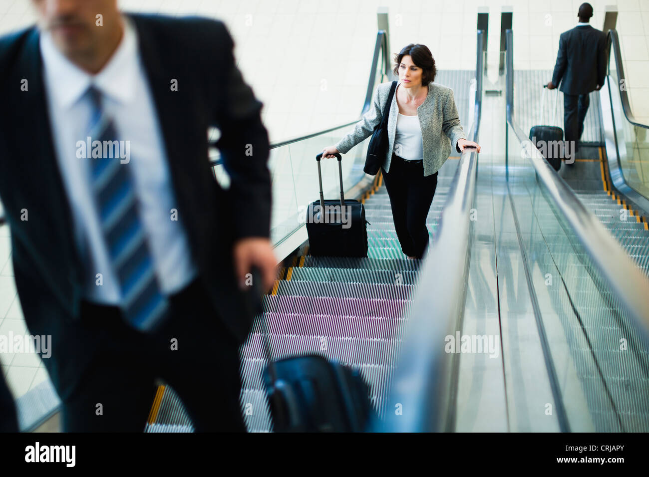 Female riding on escalator hi-res stock photography and images - Alamy