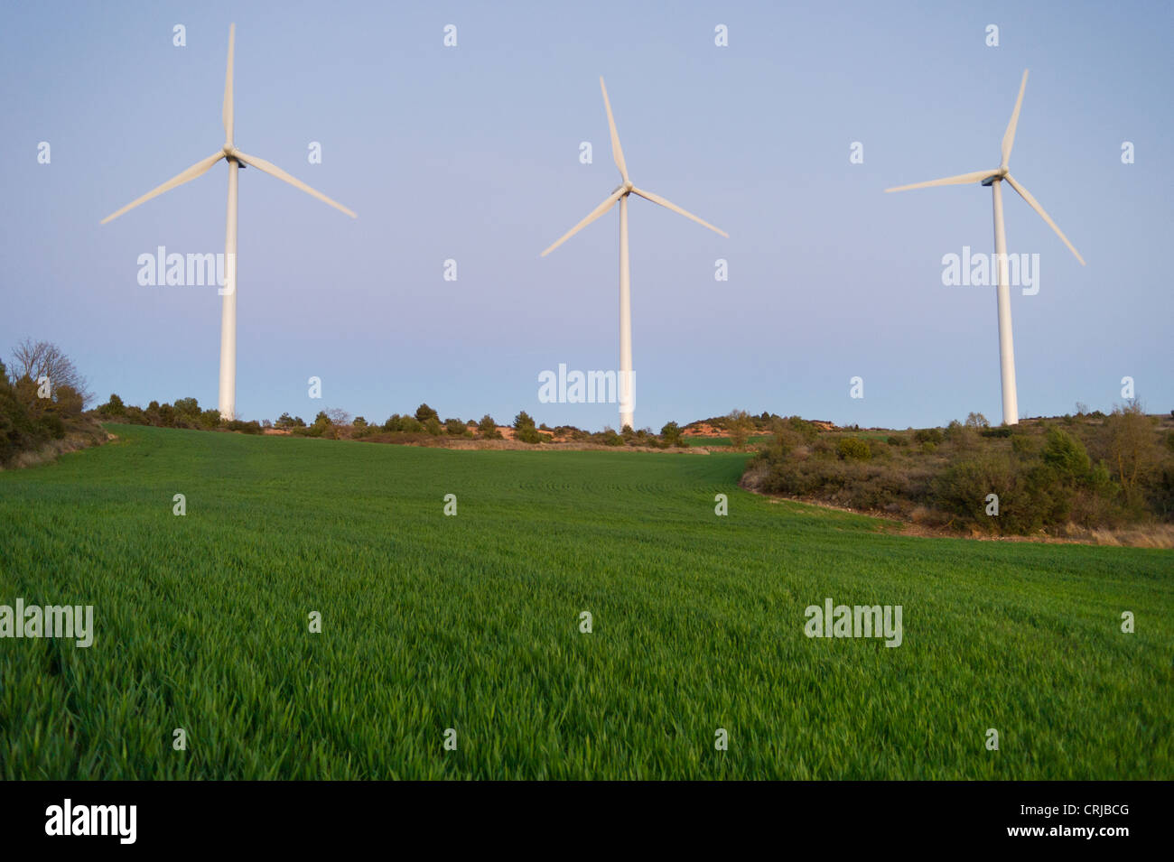 Three wind turbines and grass fields Stock Photo - Alamy