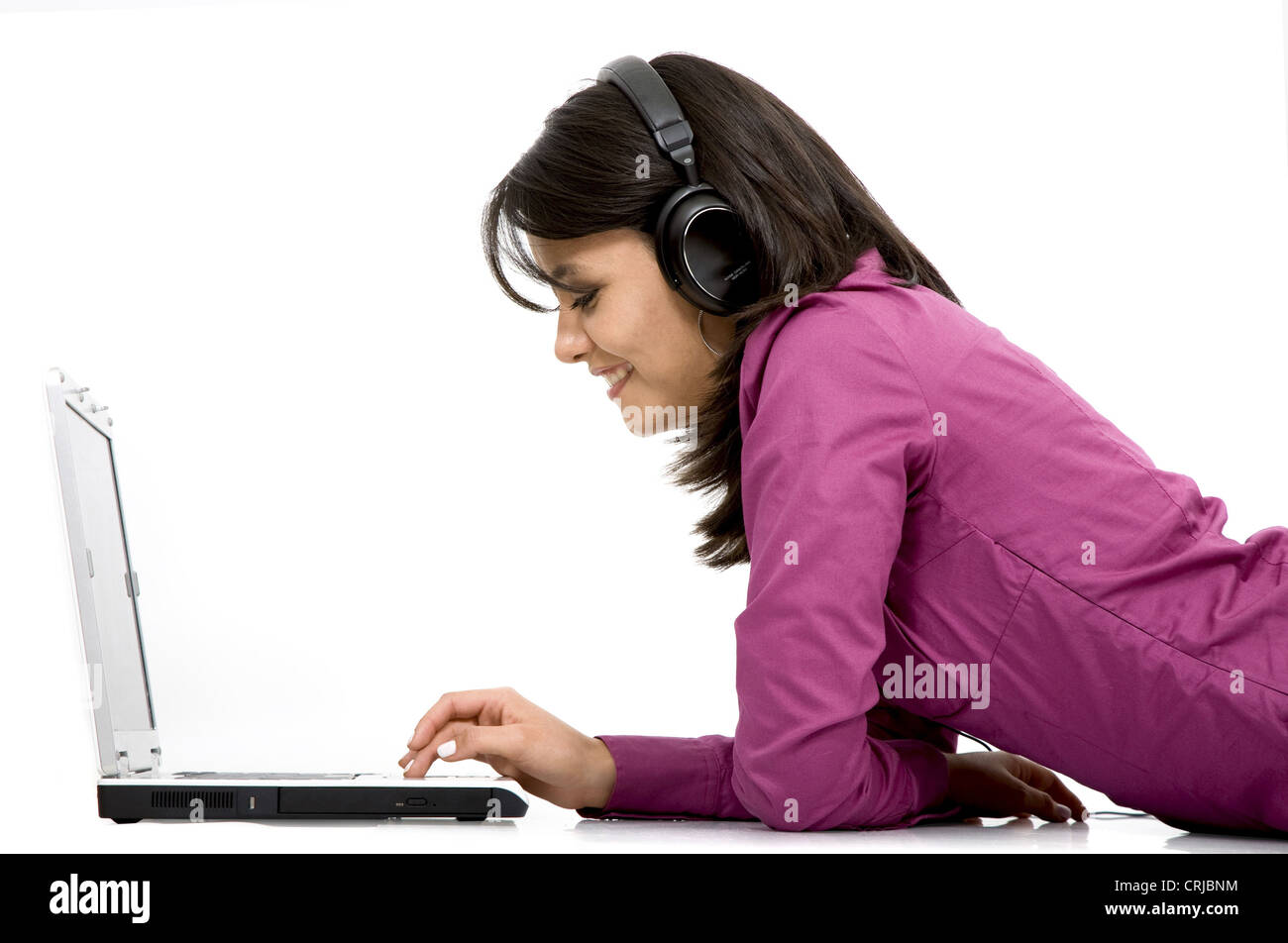 student listening to music on a laptop computer Stock Photo - Alamy