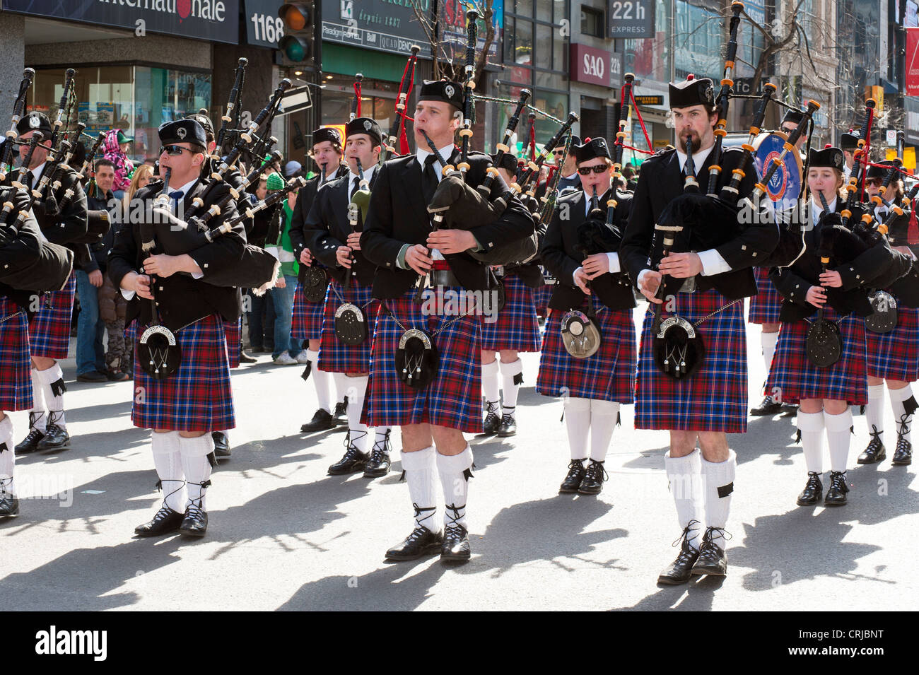 Traditional pipe band marching on Ste Catherine street in Montreal ...