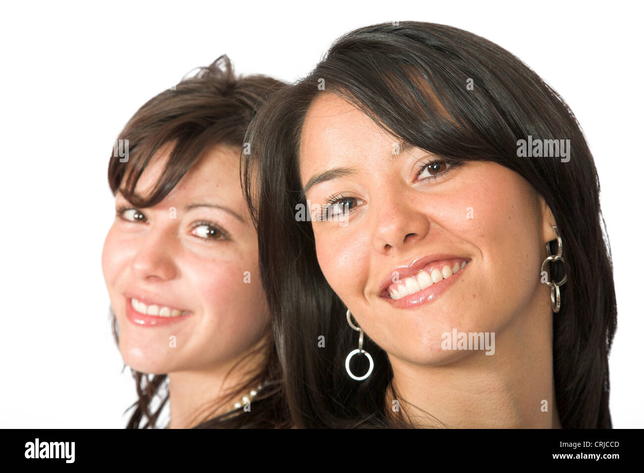beautiful female friends back to back Stock Photo - Alamy