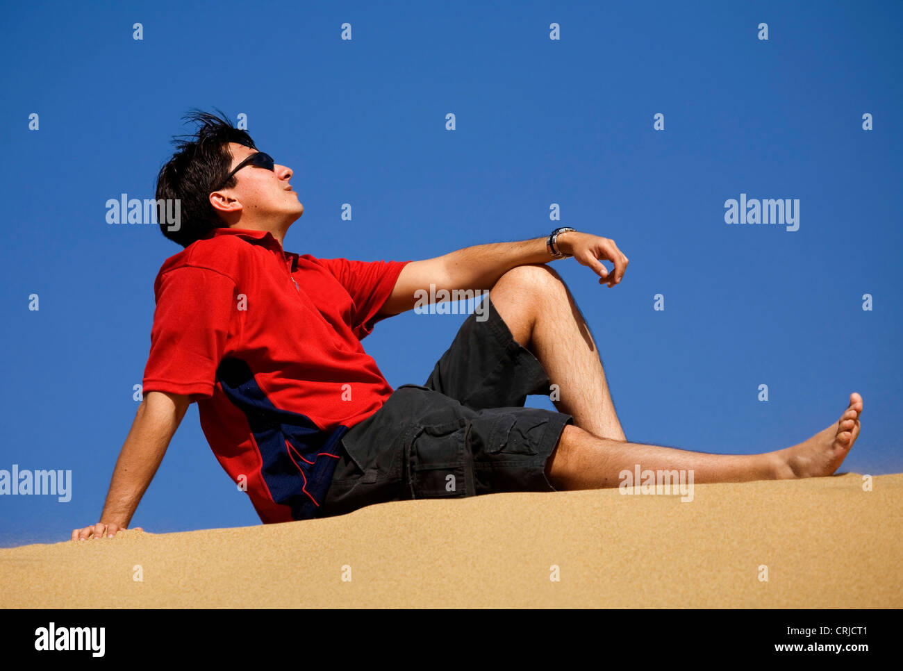 man relaxing at the beach on a sunny day Stock Photo - Alamy