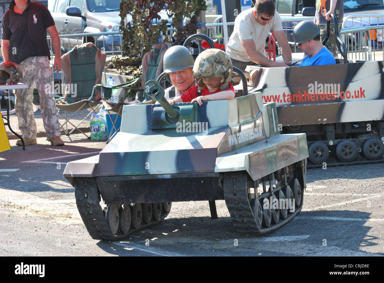 Man and boy in toy tank Stock Photo - Alamy