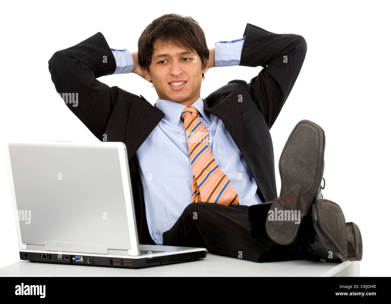 business man relaxed at work on his desk watching a laptop screen, feet ...