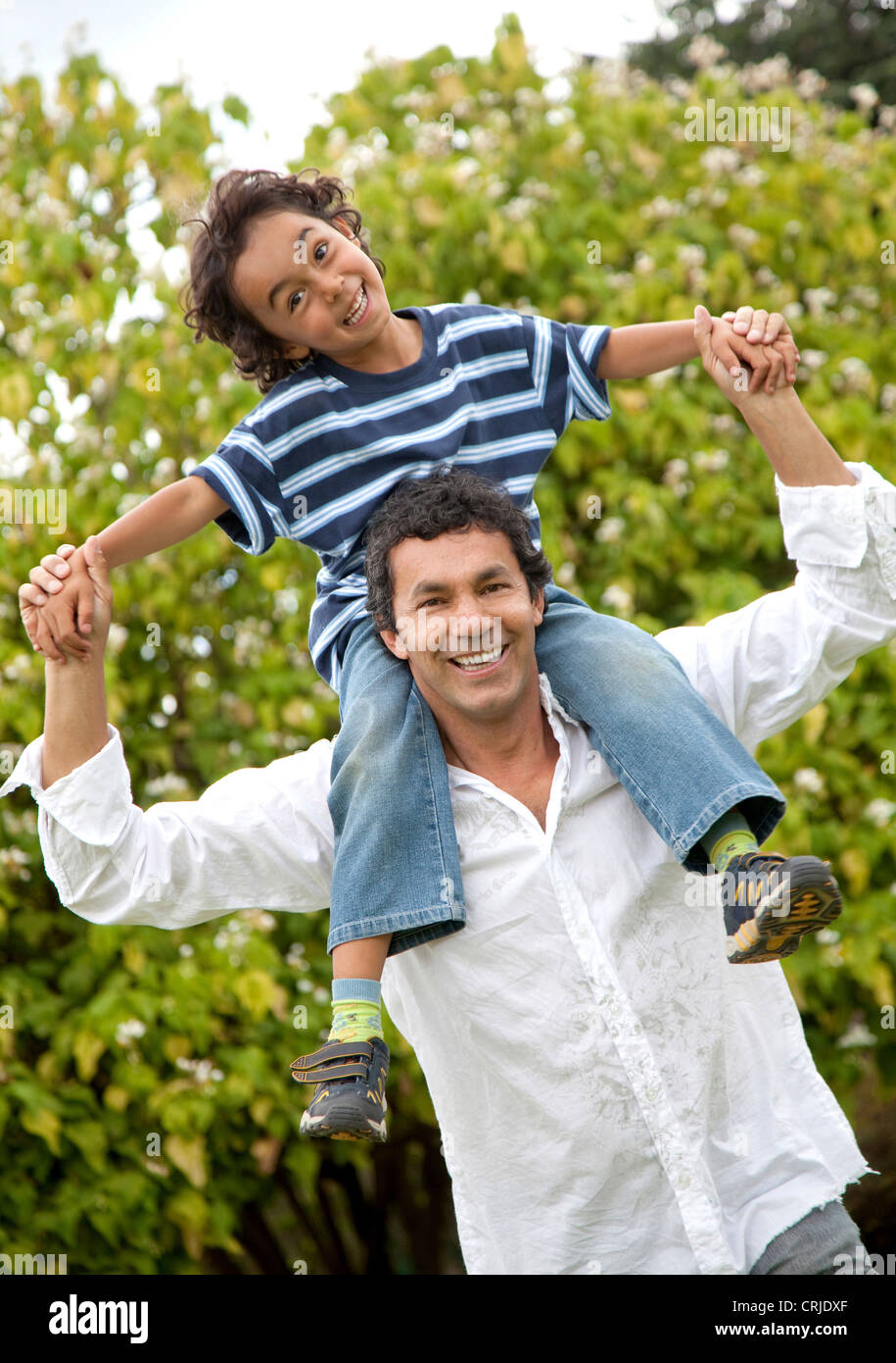 father giving a piggyback ride to his son outdoors Stock Photo - Alamy