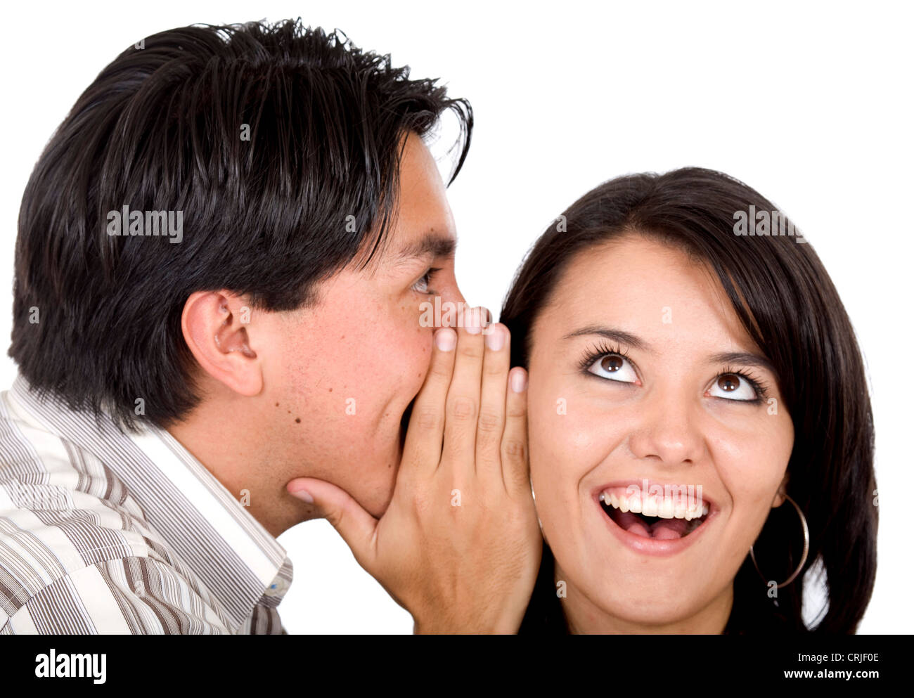 man telling a secret to a girl - she is looking surprised Stock Photo ...